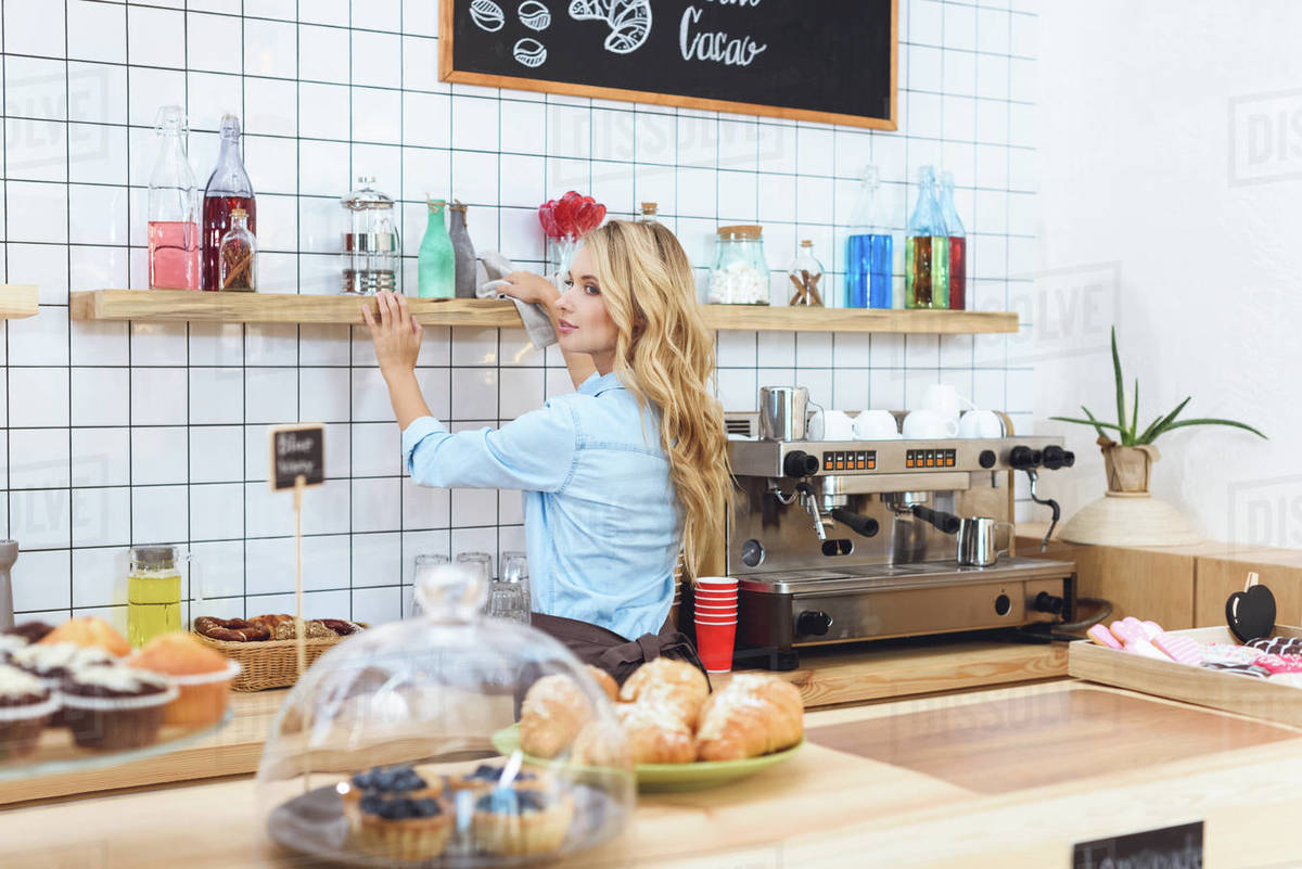 beautiful young waitress working in cafe - Stock Photo - Dissolve