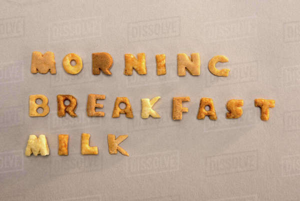 Top view of words morning, breakfast, milk from alphabet corn flakes ...