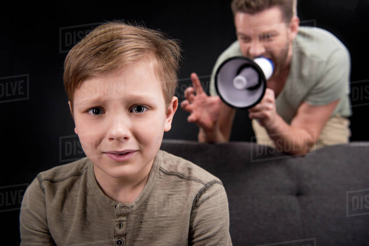 Father with megaphone screaming at scared little son, family problems ...