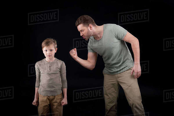 Angry father threatening and gesturing to scared little son, family ...