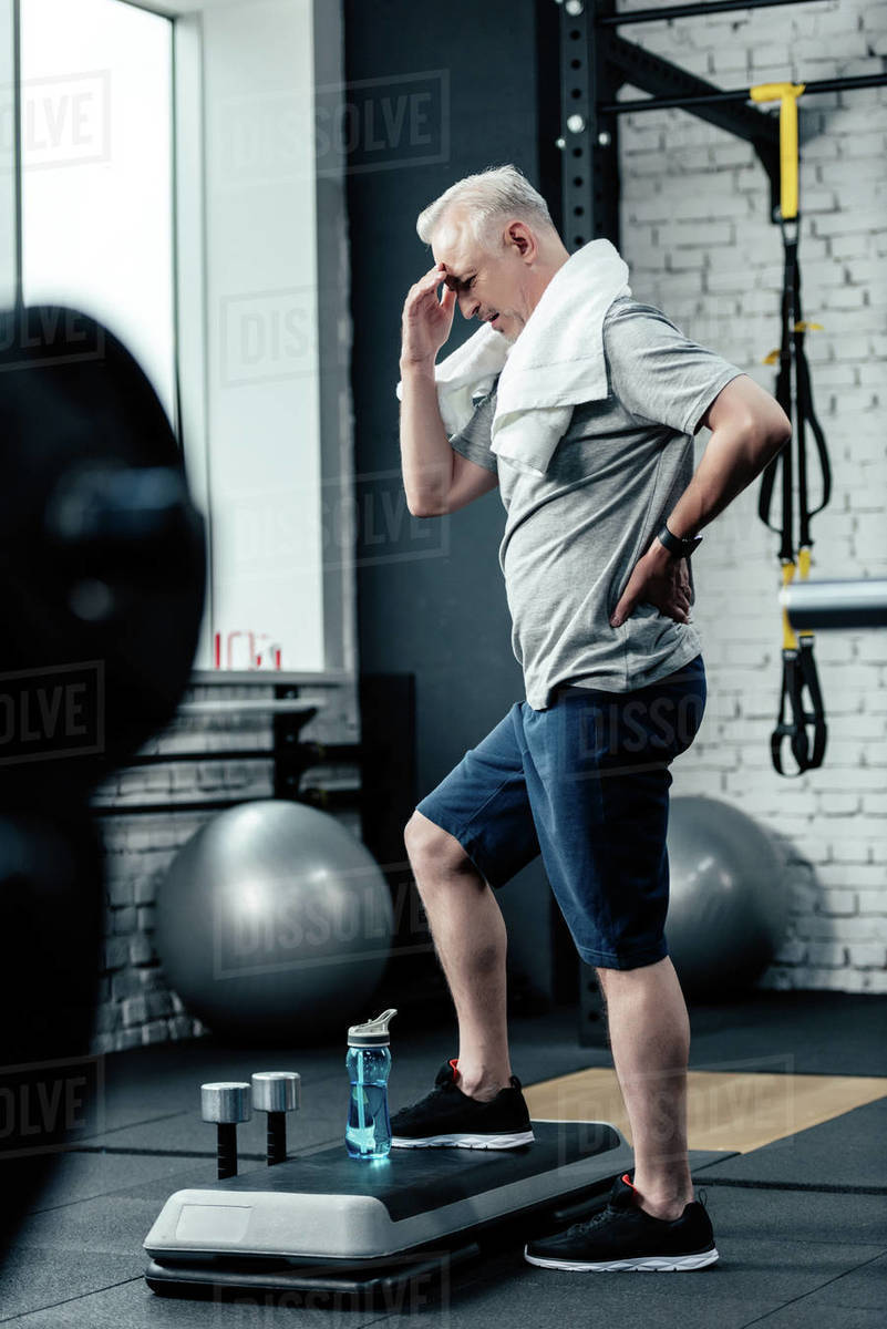 Exhausted senior sportsman standing in sport center - Royalty-free ...
