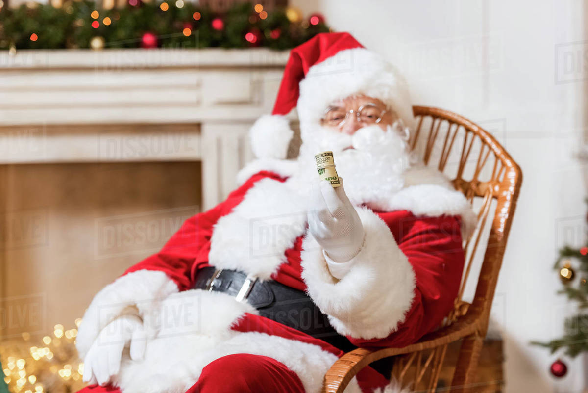 Portrait of Santa Claus holding roll of money in hand - Royalty-free ...