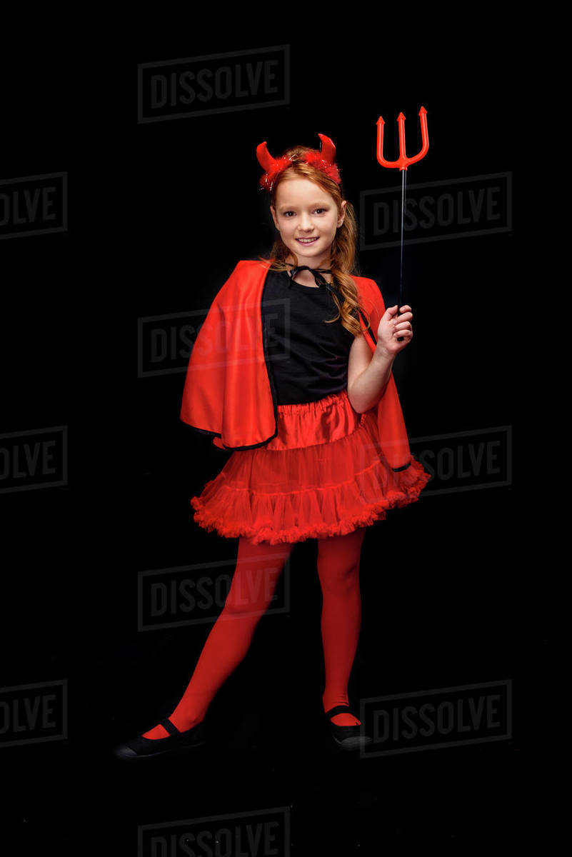Child in Halloween costume of devil with pitchfork, isolated on black ...