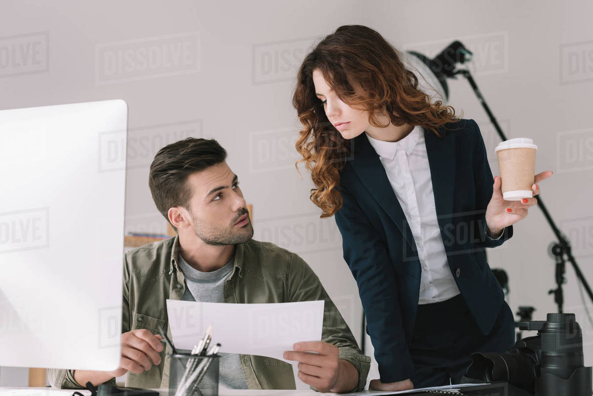 male photographer and model choosing photos for portfolio in modern ...