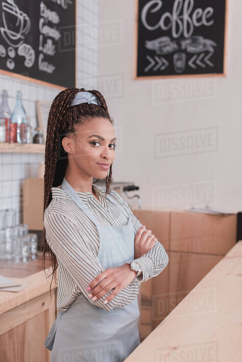 Young african american barista standing with arms crossed behind the ...