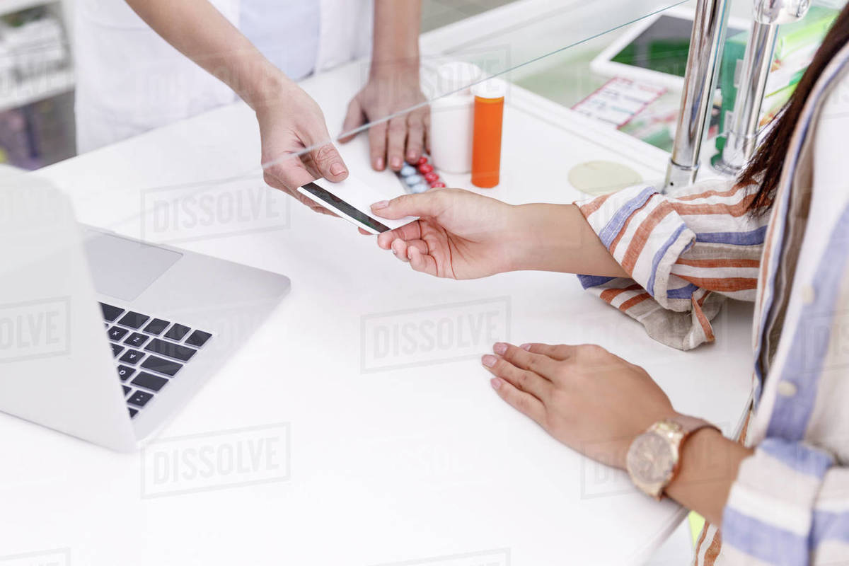 cropped shot of customer paying by credit card in drugstore - Royalty ...