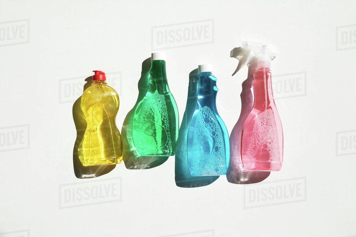 Top view of various plastic bottles with colorful cleaning fluids on ...