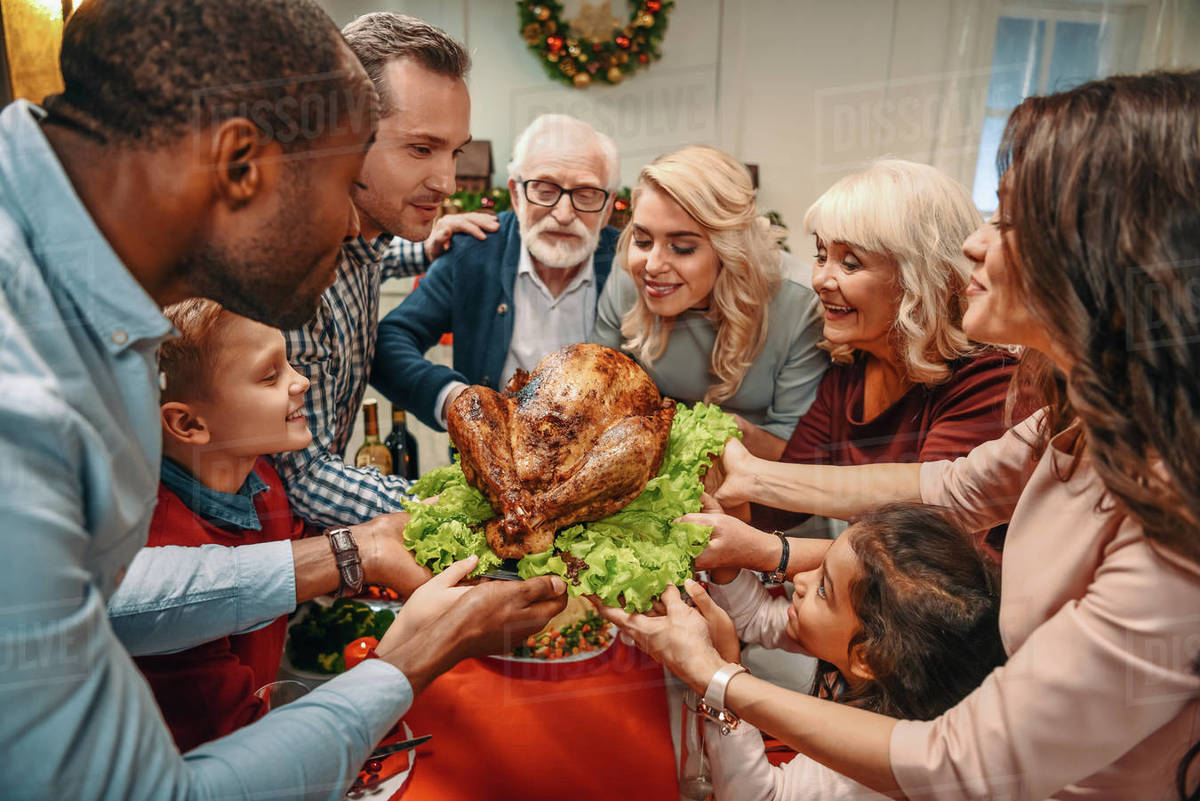 Happy large family holding Christmas turkey together - Royalty-free ...