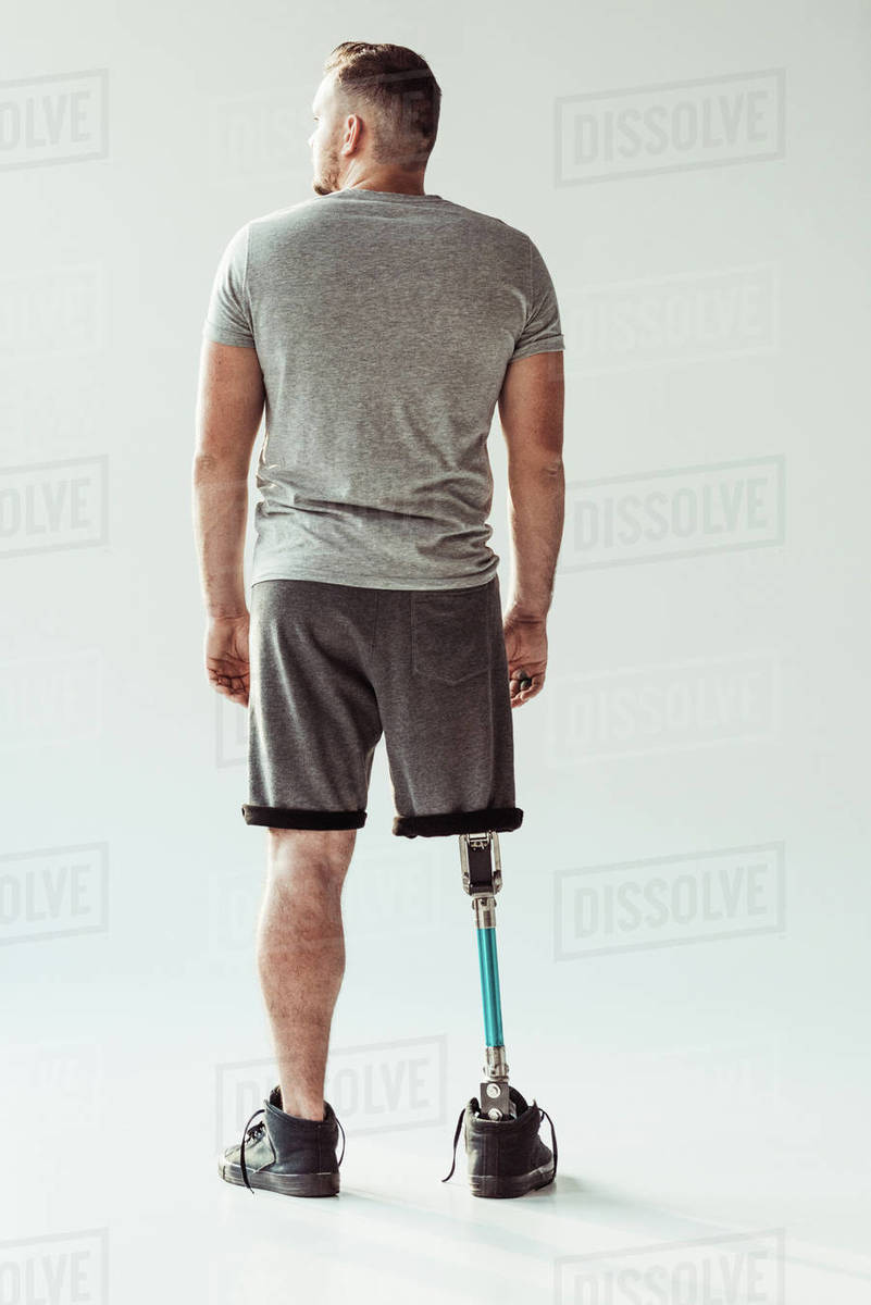 Back view of man with leg prosthesis in casual clothing isolated on ...