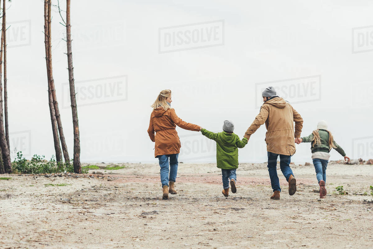 beautiful family running together and holding hands on nature - Royalty ...