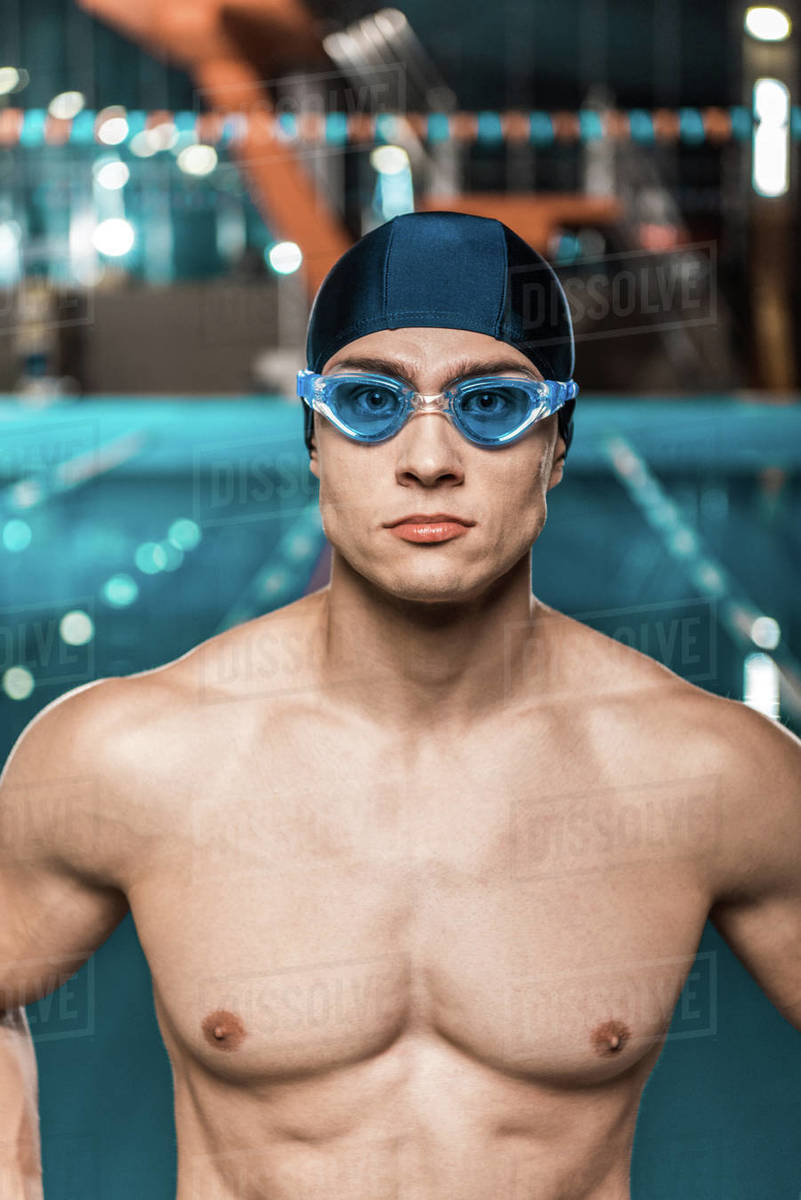 Handsome muscular swimmer in swimming cap and goggles - Royalty-free ...