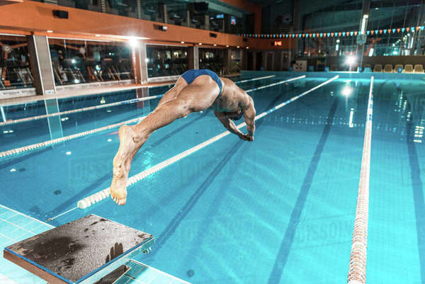 Swimmer diving into competition swimming pool - Stock Photo - Dissolve