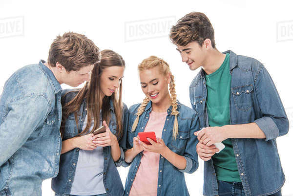 Smiling young friends using smartphones isolated on white - Royalty ...