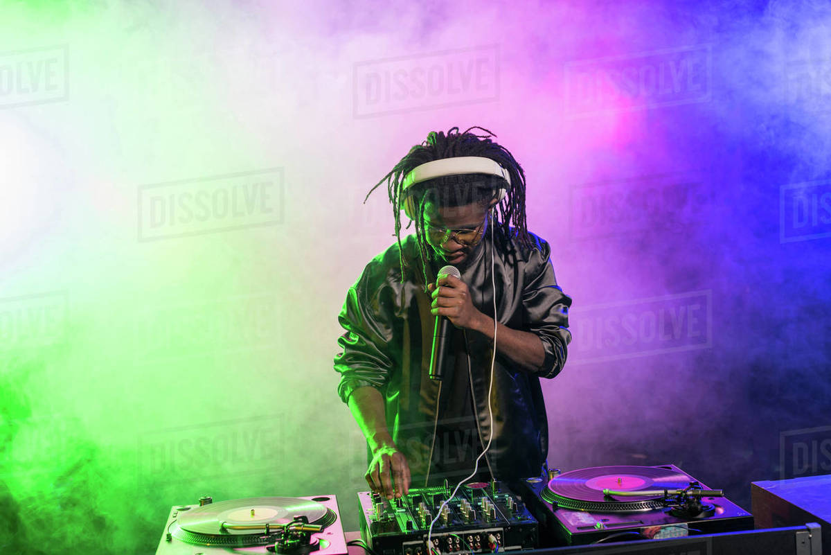 Professional African American dj in headphones with sound mixer in ...