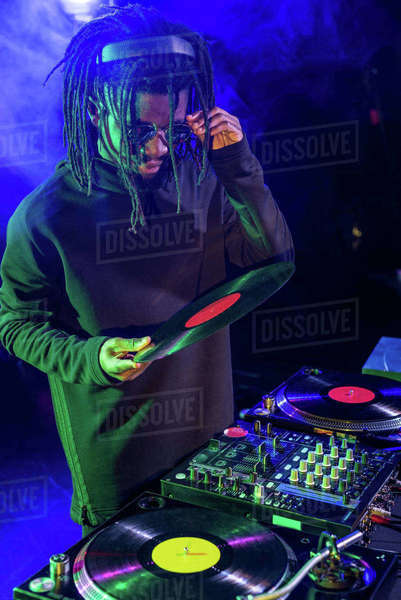 Professional African American club dj with vinyl in nightclub - Royalty ...