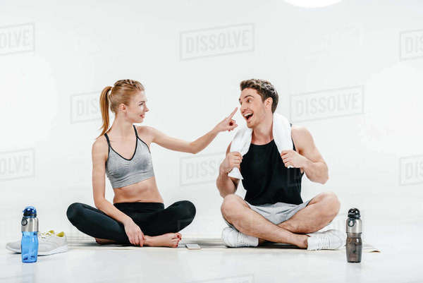 Young fit couple relaxing after working-out isolated on white - Royalty ...