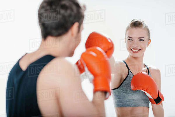 Beautiful young girl boxing with trainer isolated on white - Royalty ...