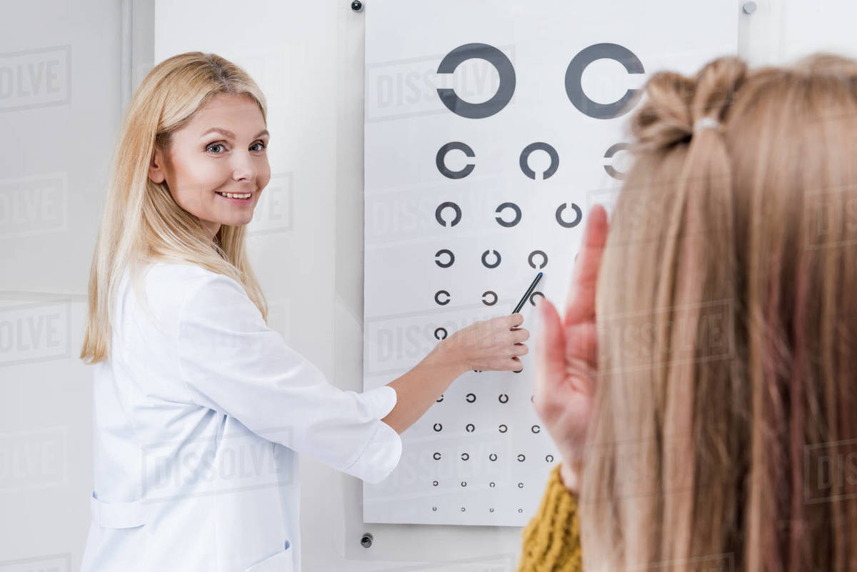 Patient and oculist doing eye test with eye chart in clinic - Royalty ...
