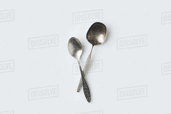 top view of crossed spoons isolated on white - Stock Photo - Dissolve