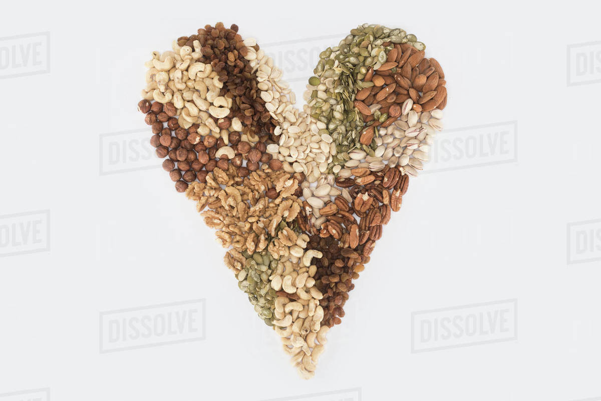 Close-up view of heart symbol made from various healthy nuts isolated ...