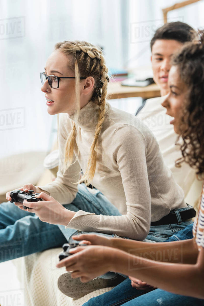 Multiethnic girls playing video game at home - Royalty-free Stock Photo ...