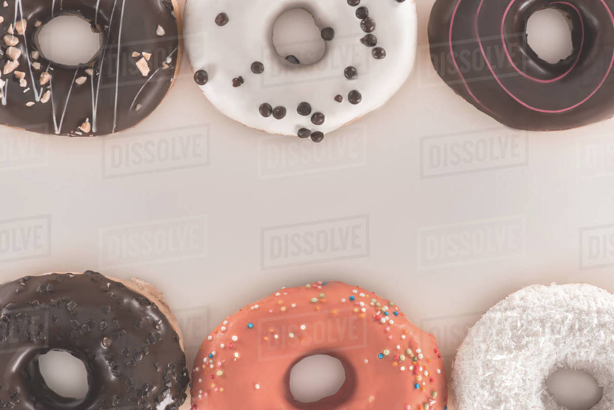 Top view of fresh tasty glazed doughnuts on grey - Royalty-free Stock ...