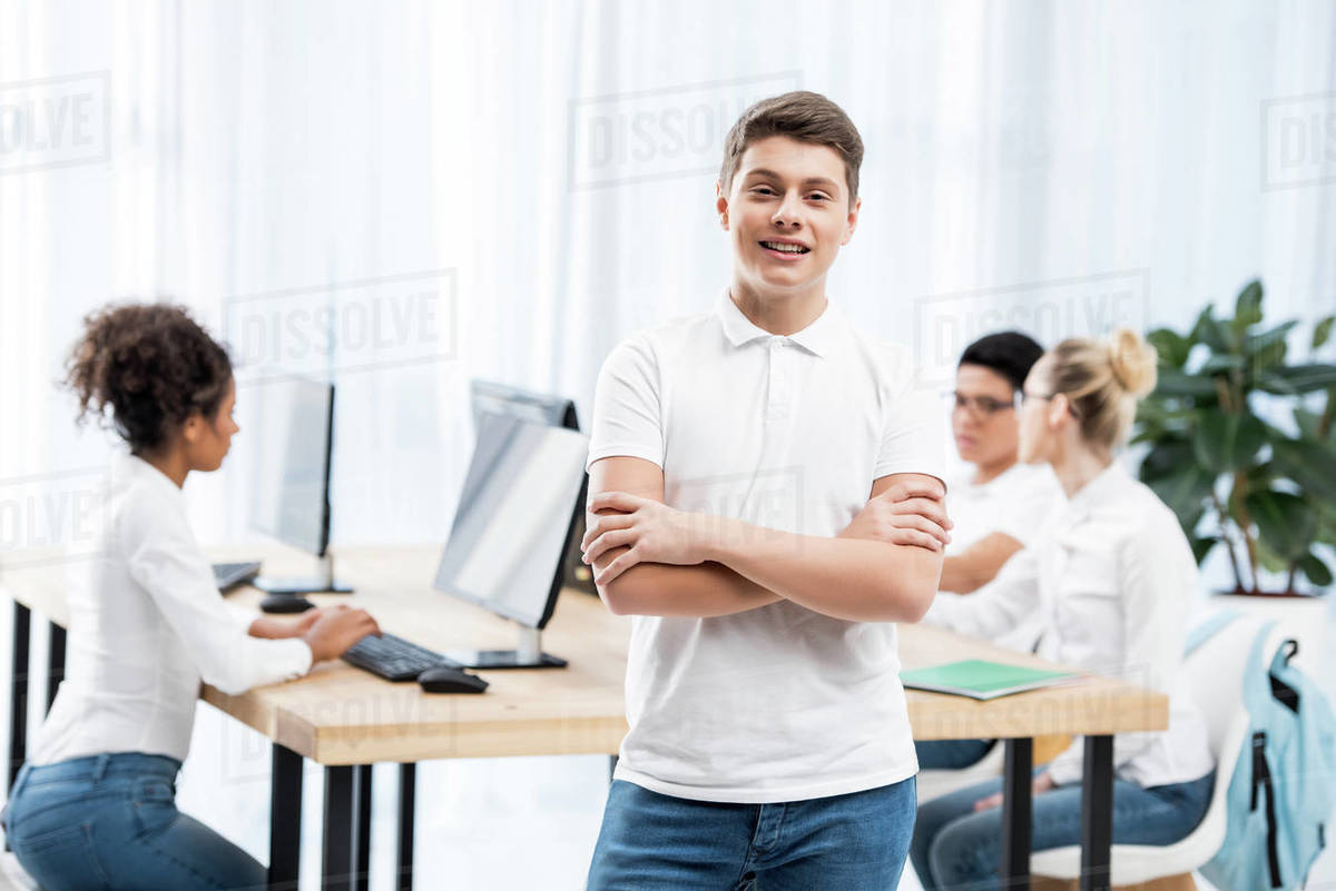 Young happy Caucasian student boy in classroom with friends - Royalty ...