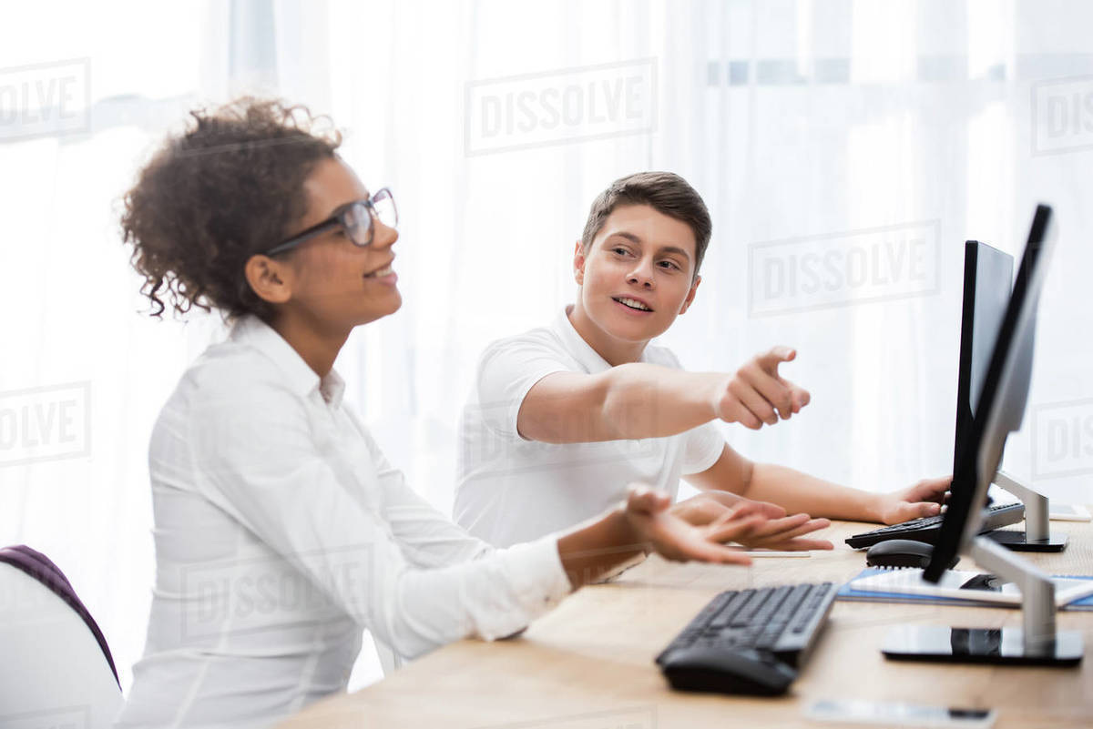 Young teenager students pointing on screen of computer - Royalty-free ...