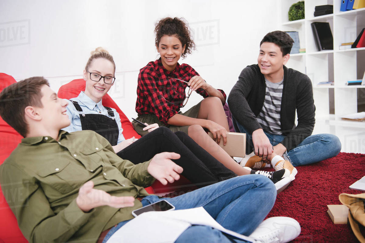 Cheerful students sitting with exercise books - Royalty-free Stock ...