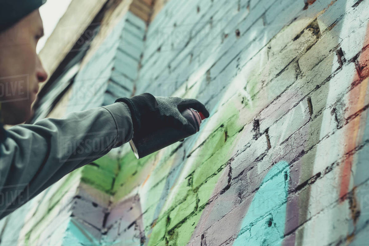 Cropped view of man painting colorful graffiti on wall - Stock Photo ...