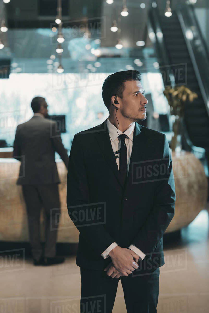 Handsome bodyguard waiting for businessman at business center - Royalty ...