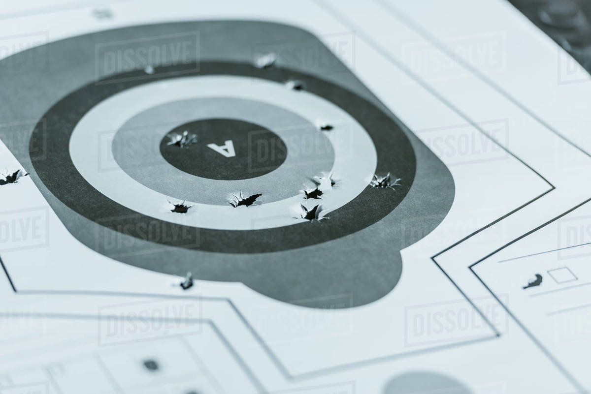 Used gun target with holes after bullets in shooting range - Stock ...