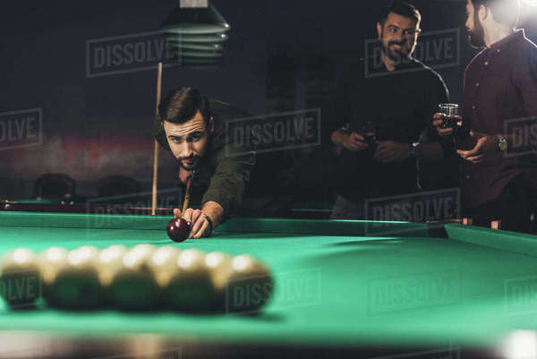 Handsome man playing in pool at bar with friends - Royalty-free Stock ...