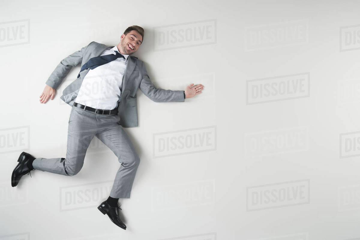 Overhead view of smiling businessman in suit isolated on grey - Royalty ...