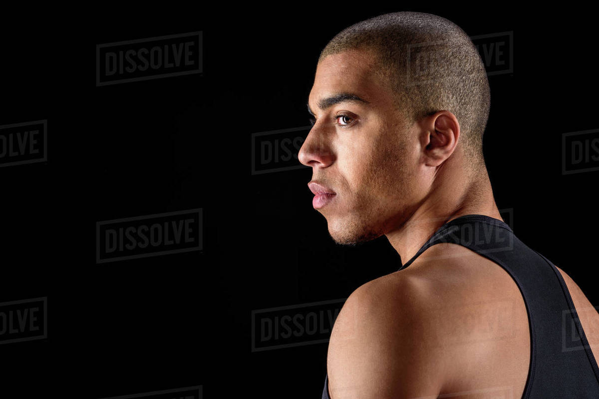 side view of african american man looking away isolated on black ...