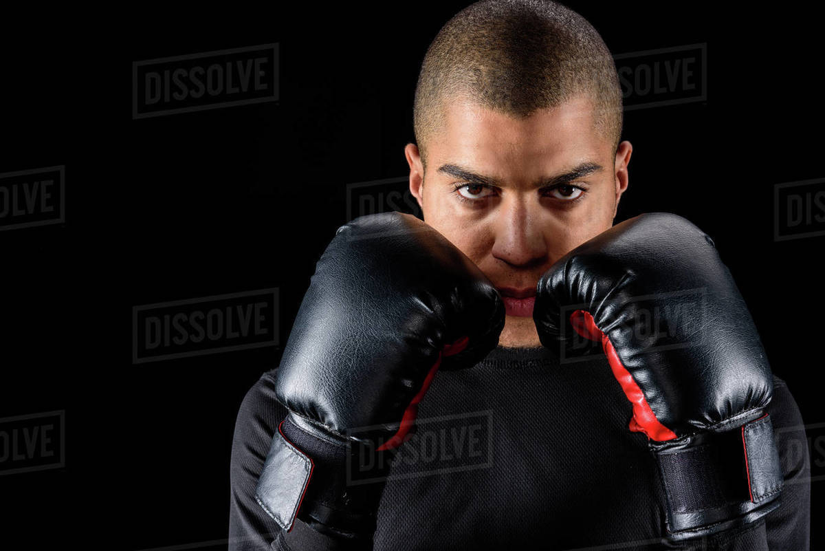 serious african american boxer in defence position isolated on black ...