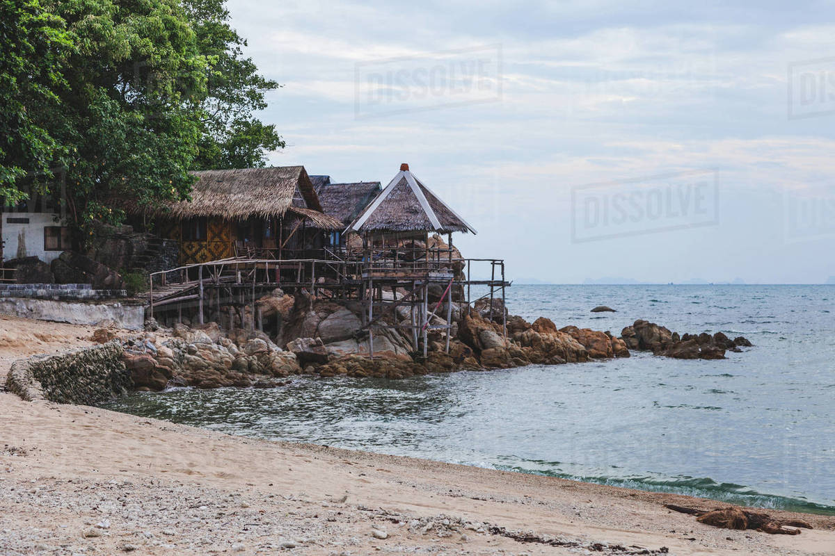 Cozy wooden shacks at sea coast on cloudy day - Royalty-free Stock ...