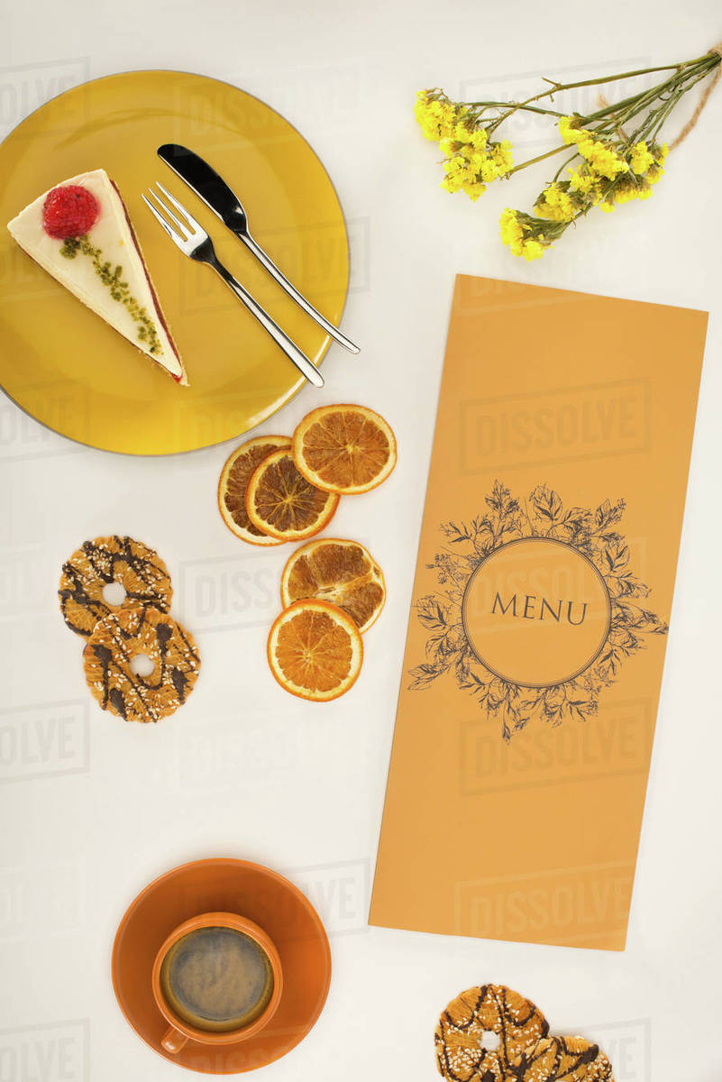 Top view of decorative menu with coffee and delicious dessert on white ...