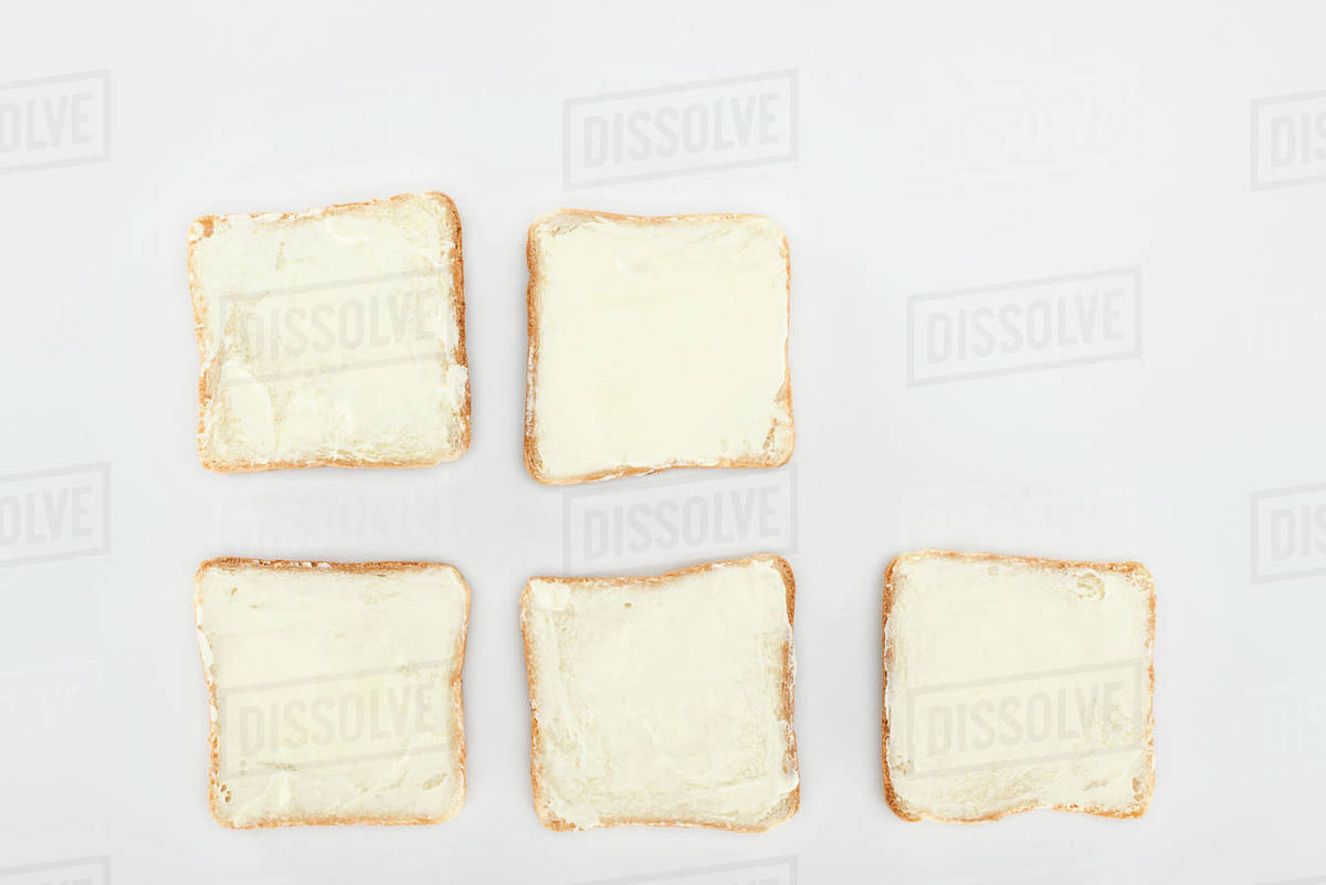 Top view of fresh toasts with butter isolated on grey - Stock Photo ...