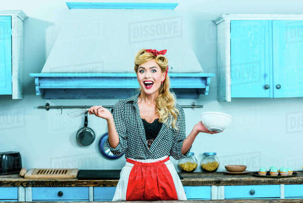 Beautiful excited pin up girl cooking in kitchen - Royalty-free Stock ...