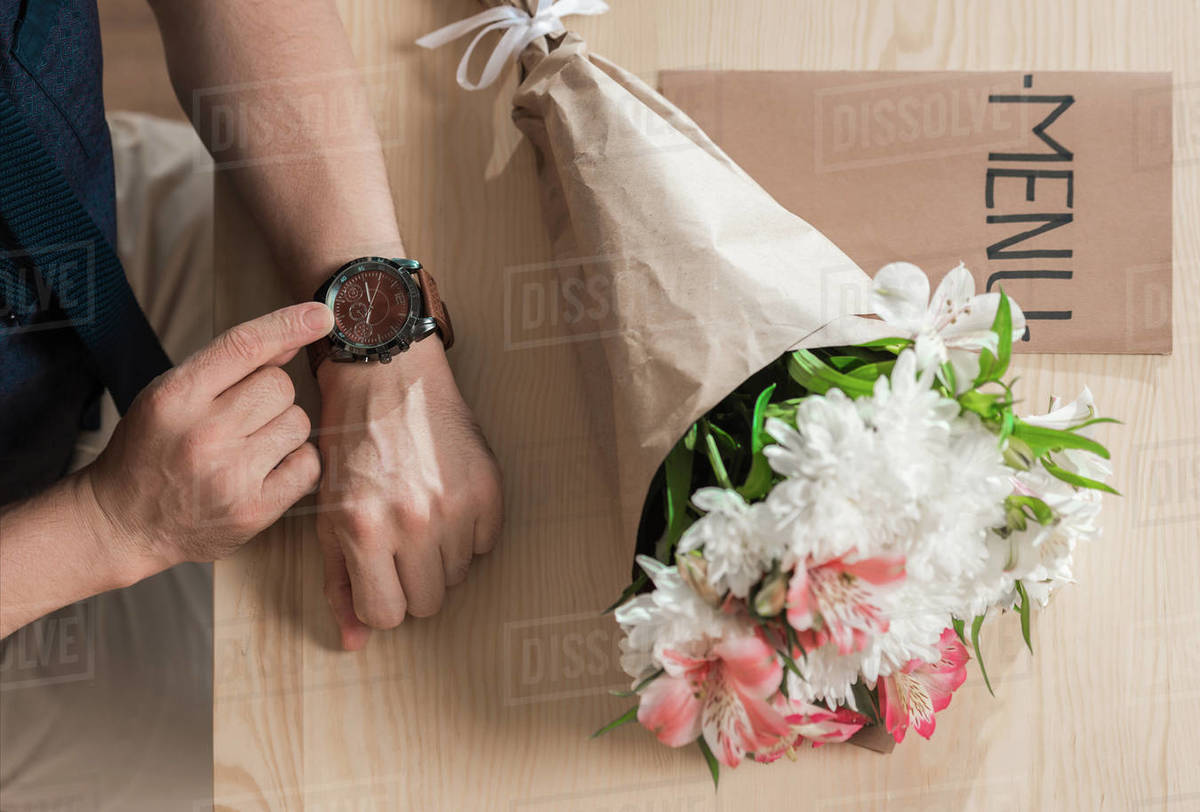 Top view of man looking at watch while waiting woman - Royalty-free ...