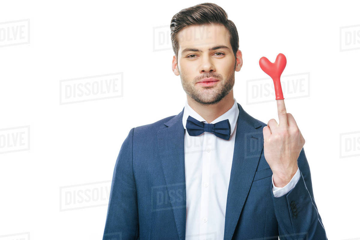 Portrait of man in suit with heart shaped balloon on middle finger ...