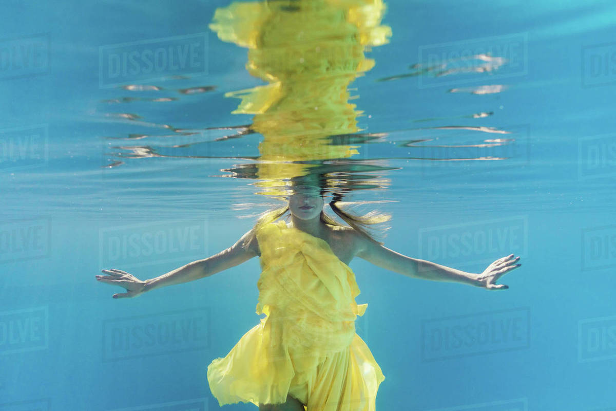 Partial view of woman in dress swimming underwater - Royalty-free Stock ...