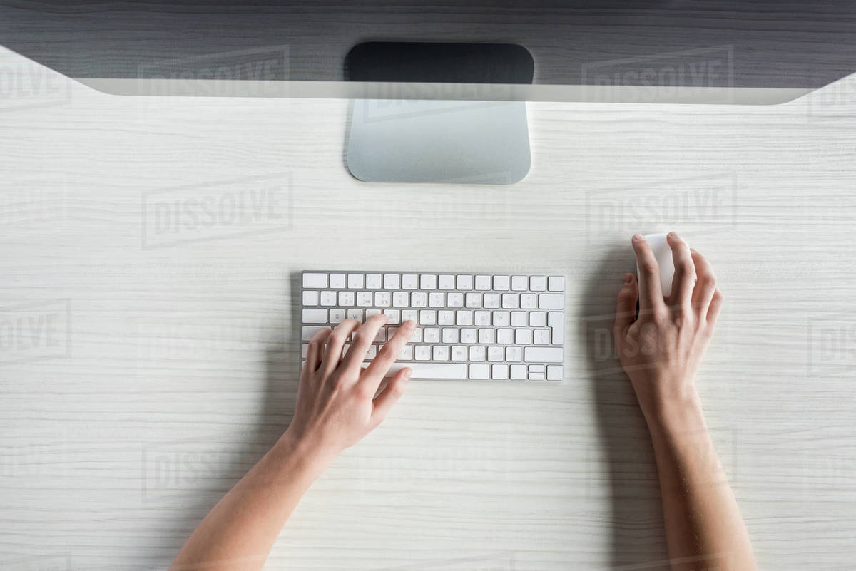 Cropped shot of student typing on keyboard while working on computer ...