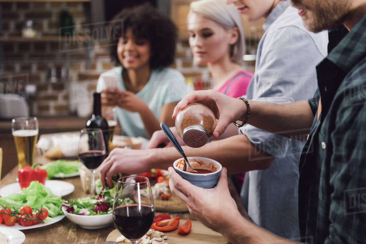 Cropped image of man adding spice to sauce - Royalty-free Stock Photo ...