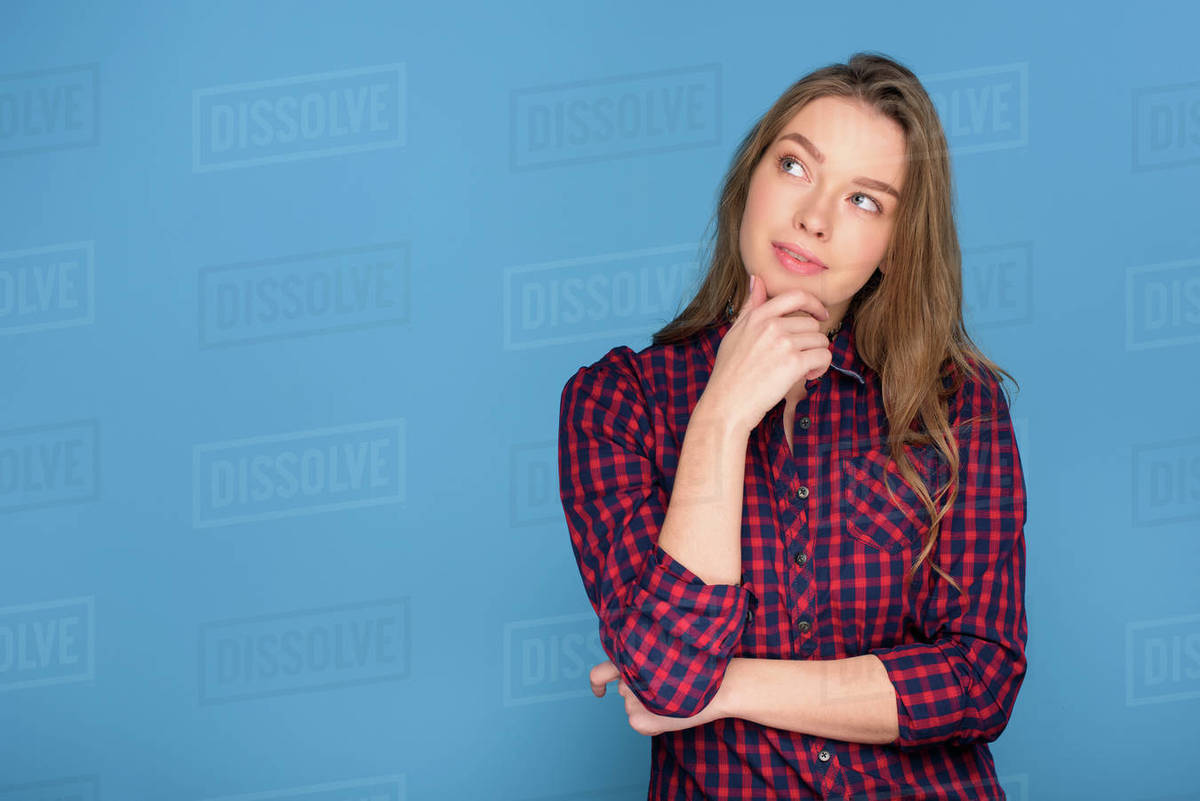 Beautiful young thoughtful girl, isolated on blue - Royalty-free Stock ...