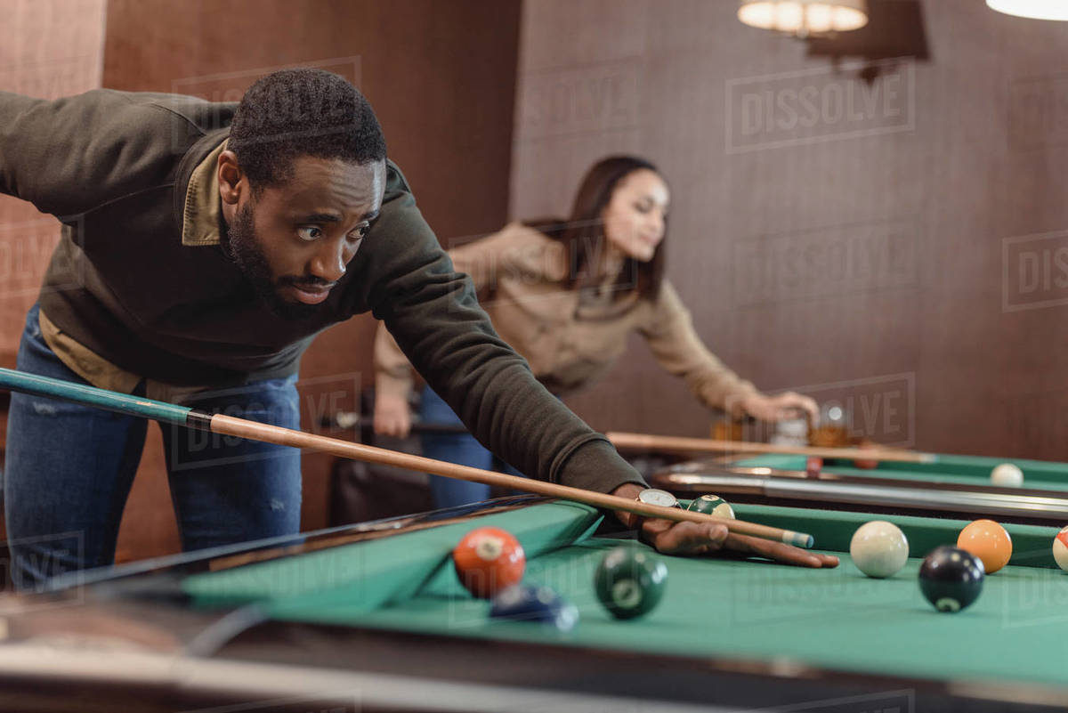 african american man playing in pool at bar with friends - Royalty-free ...