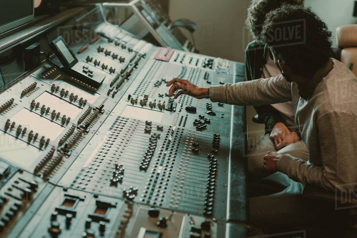 modern musicians working with graphic equalizer at recording studio ...