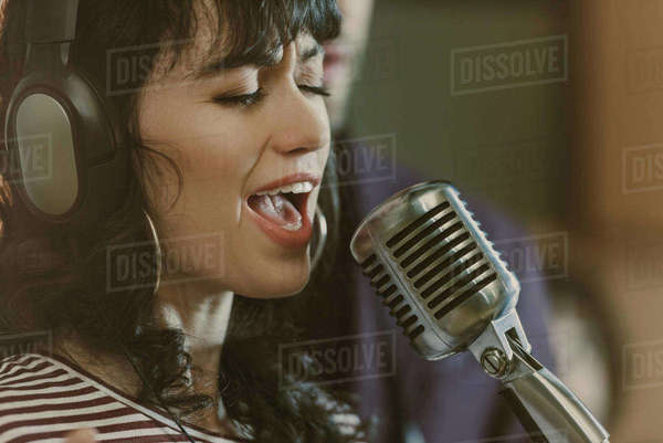 sensual young female singer performing song - Stock Photo - Dissolve