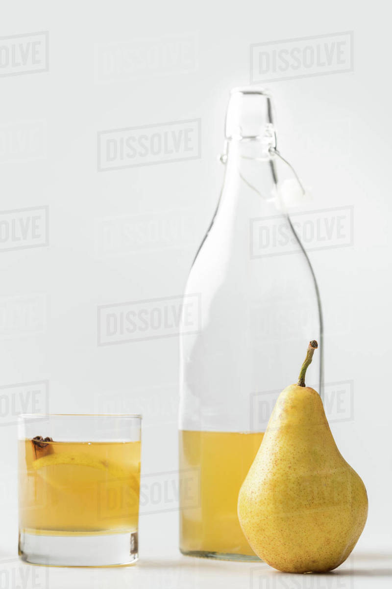 bottle and glass of pear cider with spices on white - Royalty-free ...